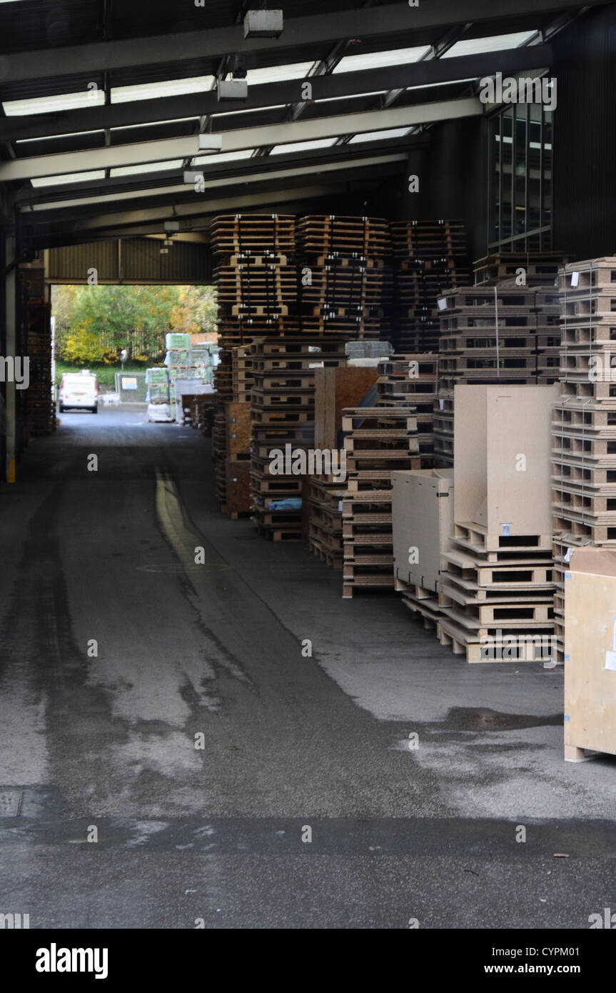 Piles of storage pallets in a warehouse Stock Photo - Alamy