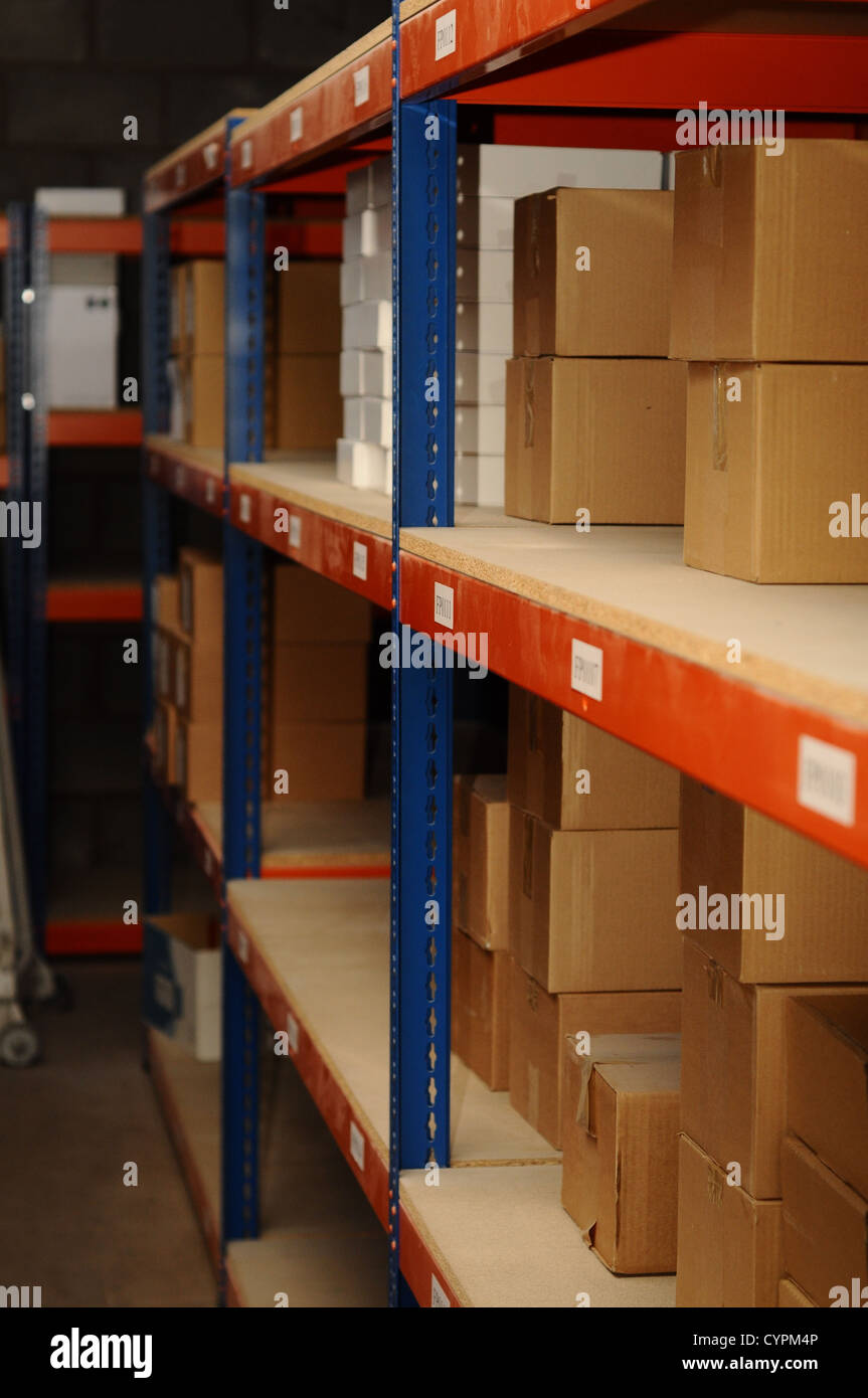 Rows of boxes and packages on shelves in a warehouse waiting to be ...