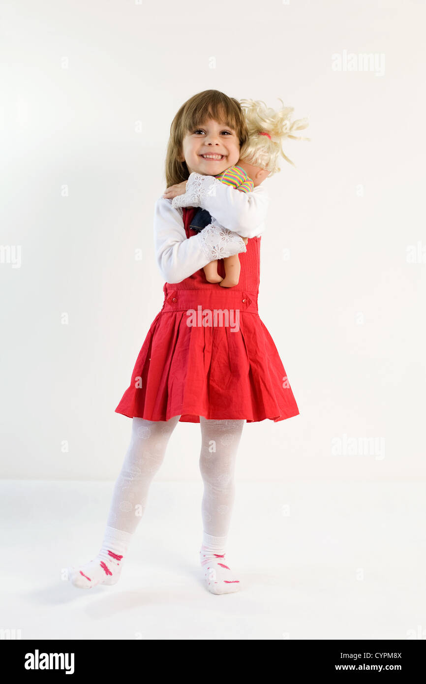 Child hugging her doll hi-res stock photography and images - Alamy