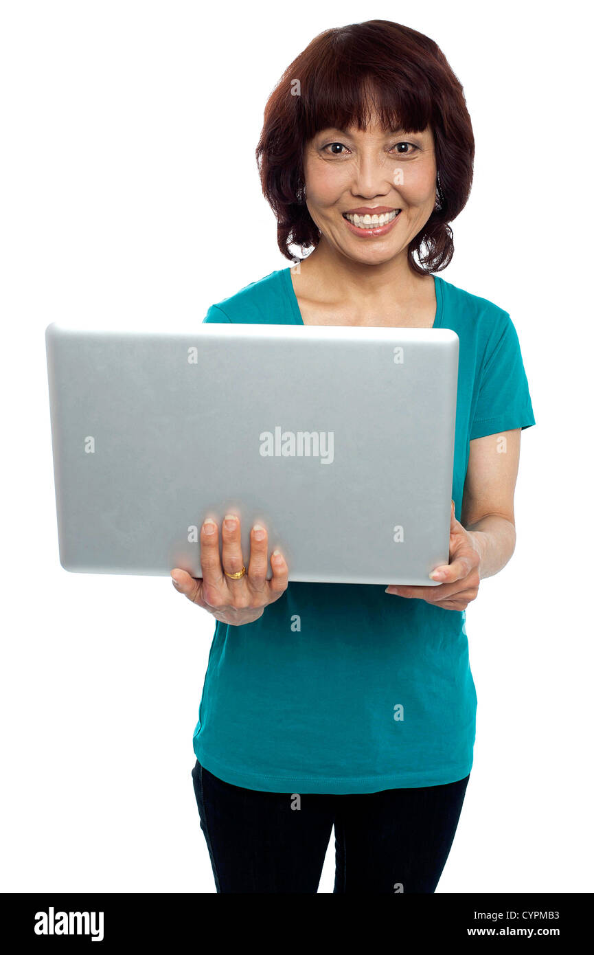 Casual asian girl holding laptop isolated against white background ...