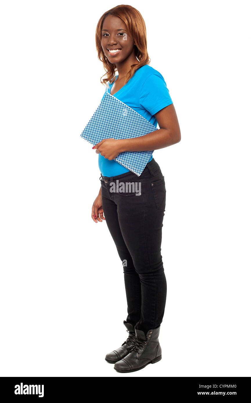 Full length portrait of pretty college student posing with her notebook ...
