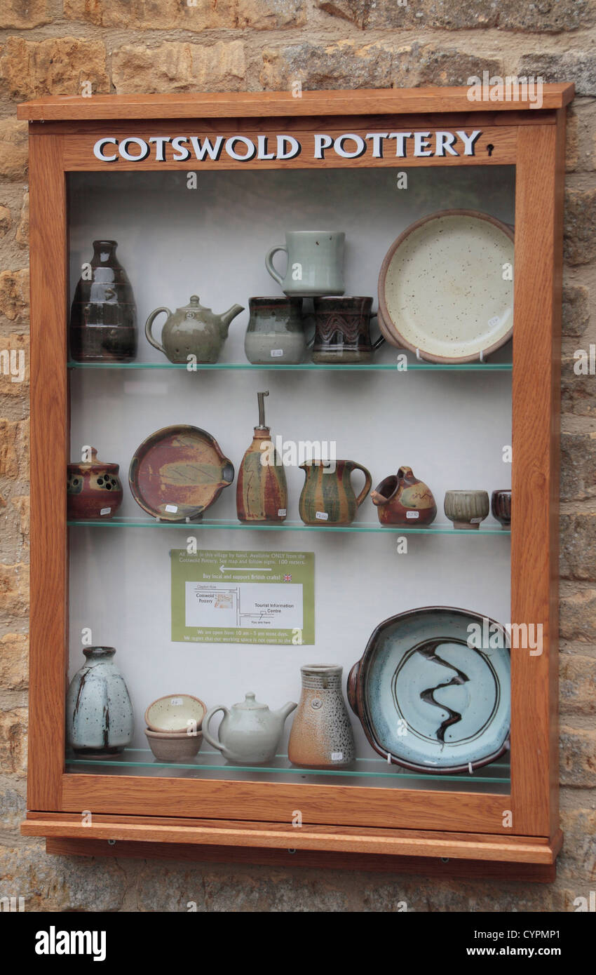 A display of Cotswold Pottery on a wall in the Cotswold village of ...
