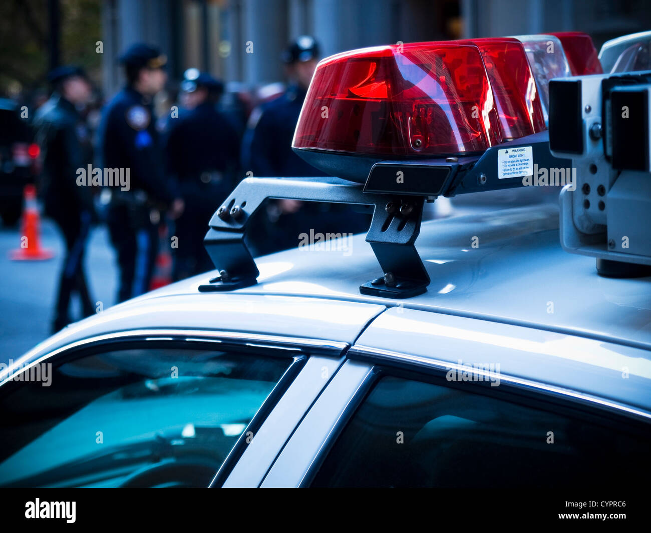 Police car lights close up. A group of policemen on the background ...
