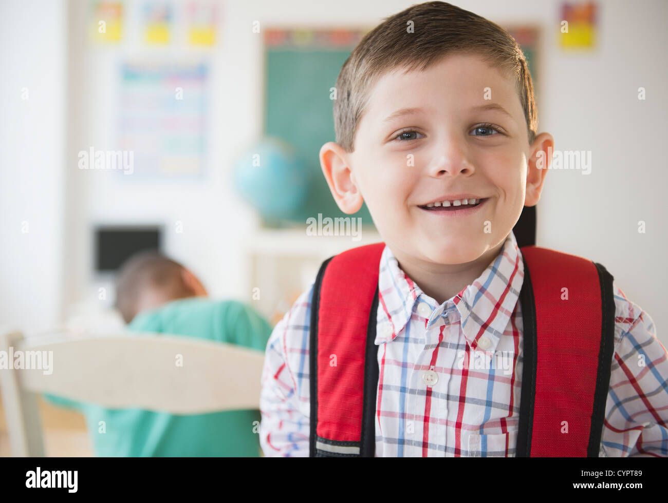 Smiling Caucasian boy in classroom Stock Photo - Alamy