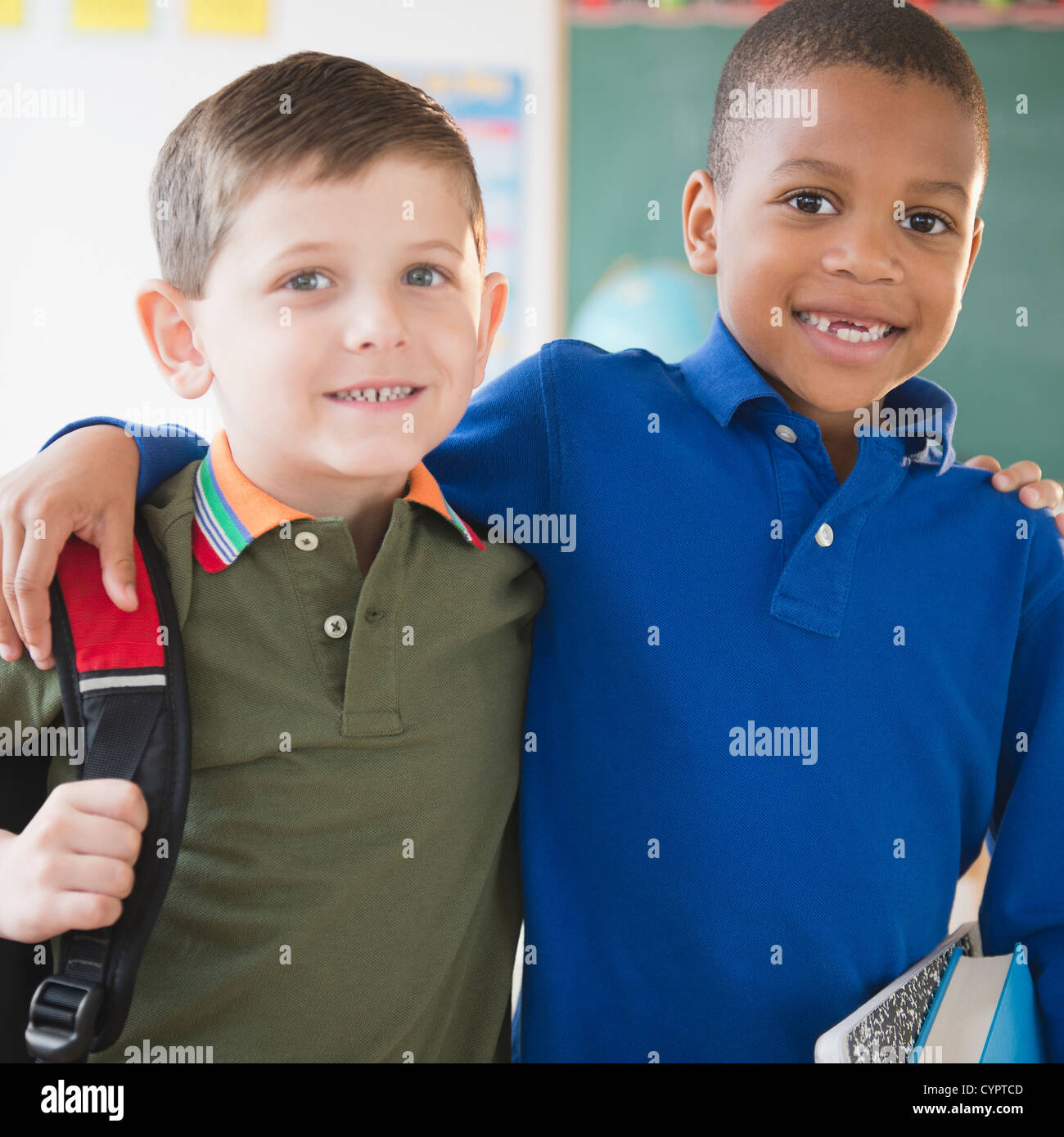 Boys hugging in classroom Stock Photo - Alamy