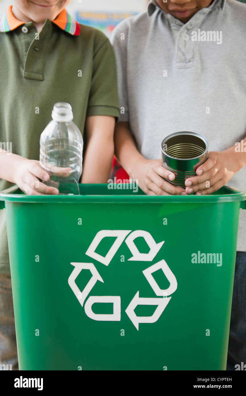 Boys recycling together Stock Photo - Alamy