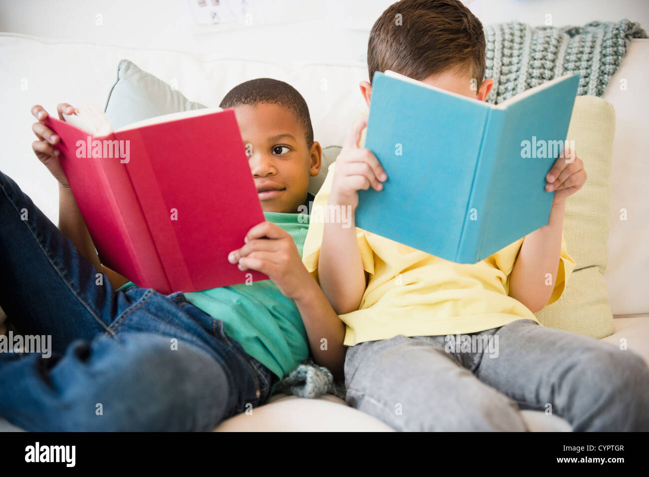 Boys reading books together Stock Photo - Alamy