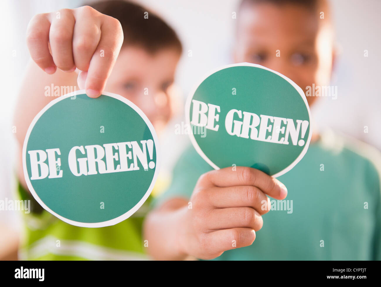 Boys holding Be Green signs Stock Photo - Alamy