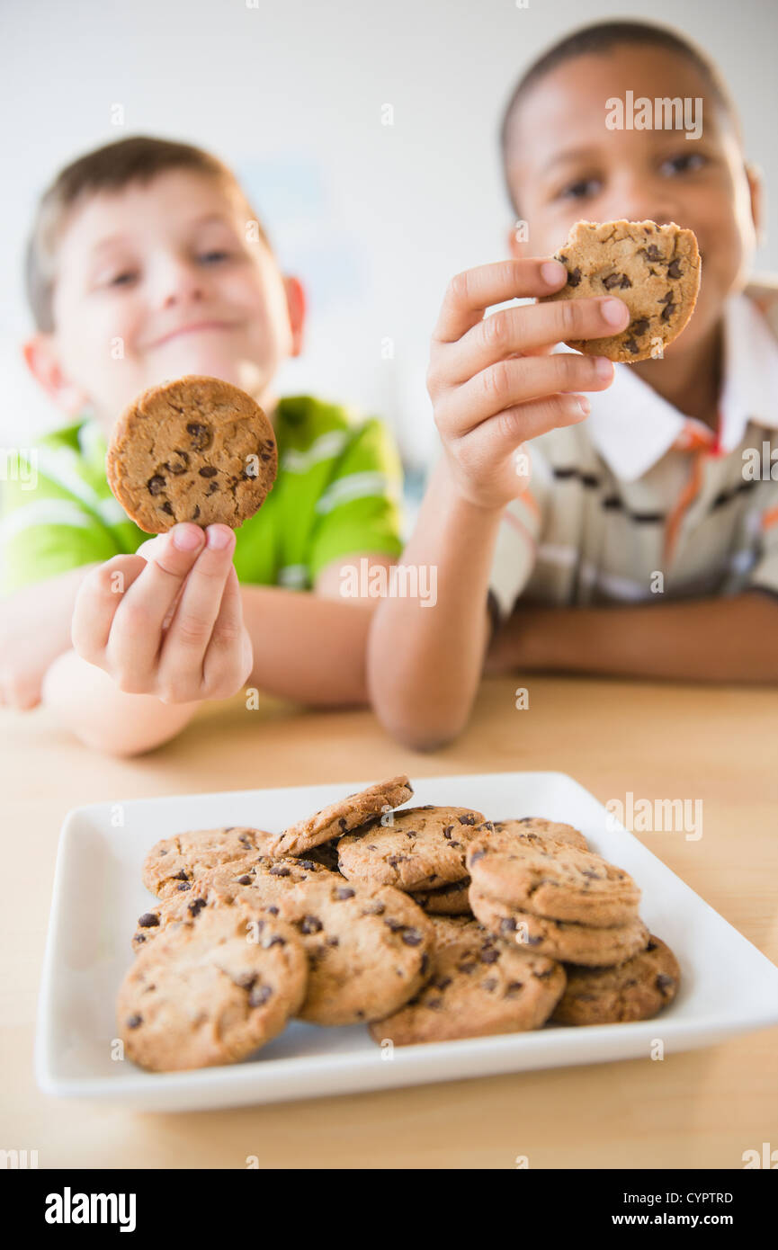 Boys eating chocolate chip cookies Stock Photo - Alamy
