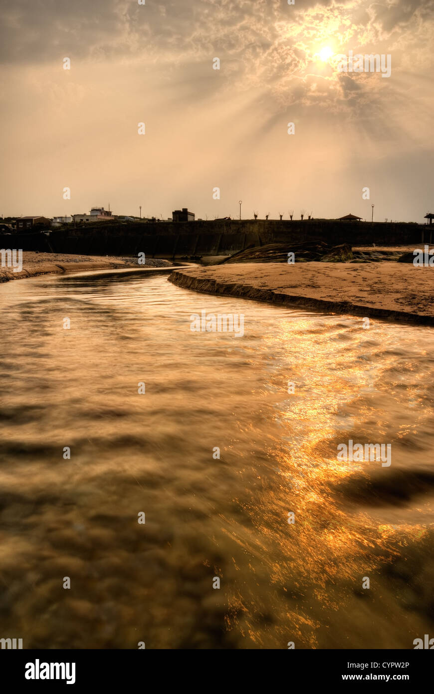 Sunset on river in yellow color with building silhouette Stock Photo ...