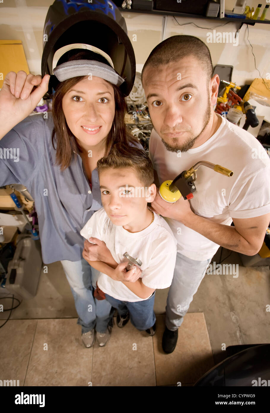 Funny Hispanic family in garage with variety of tools Stock Photo - Alamy