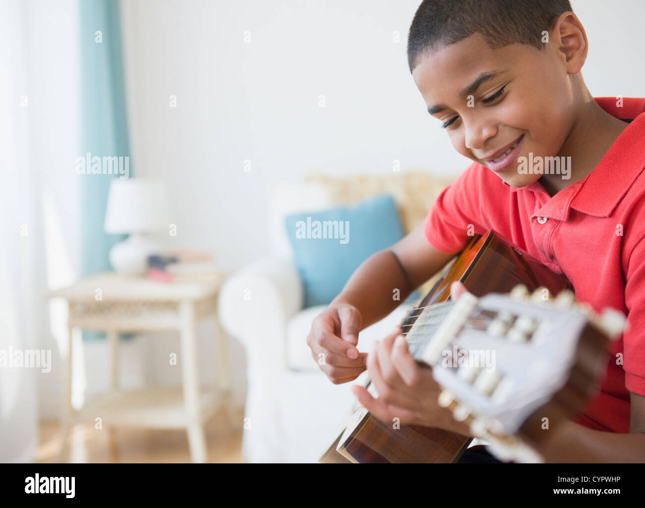 Latin boy playing guitar hi-res stock photography and images - Alamy