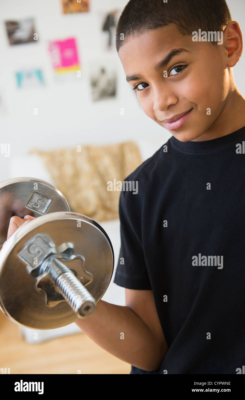 Hispanic boy lifting weights Stock Photo - Alamy