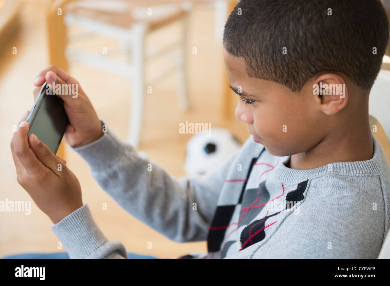 Hispanic boy using cell phone Stock Photo - Alamy