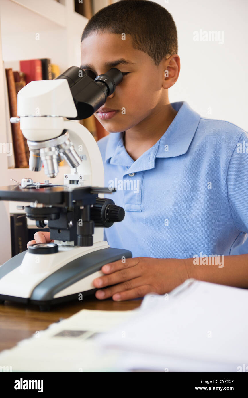 Hispanic boy using microscope Stock Photo - Alamy