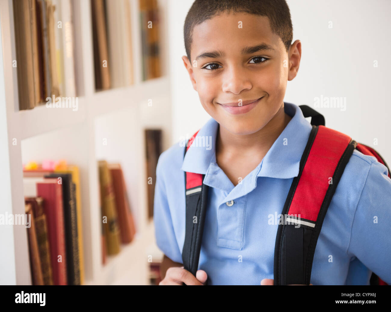 Smiling Hispanic boy carrying backpack Stock Photo - Alamy