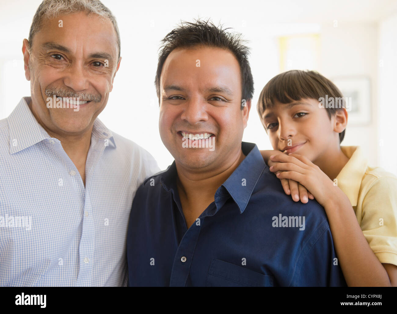 Smiling Hispanic grandfather, father and son Stock Photo - Alamy