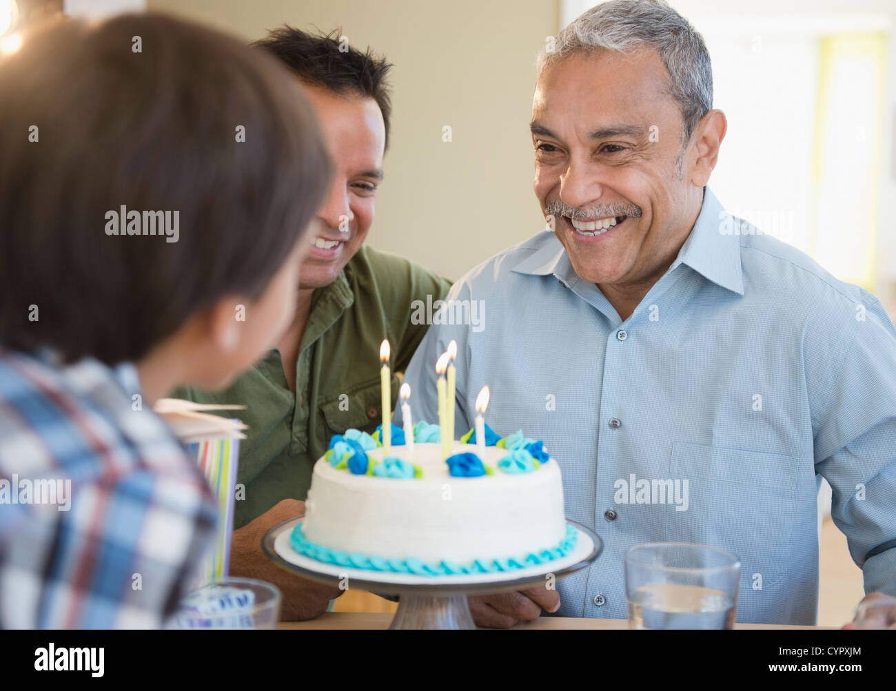 Hispanic grandfather, father and son celebrating birthday Stock Photo ...