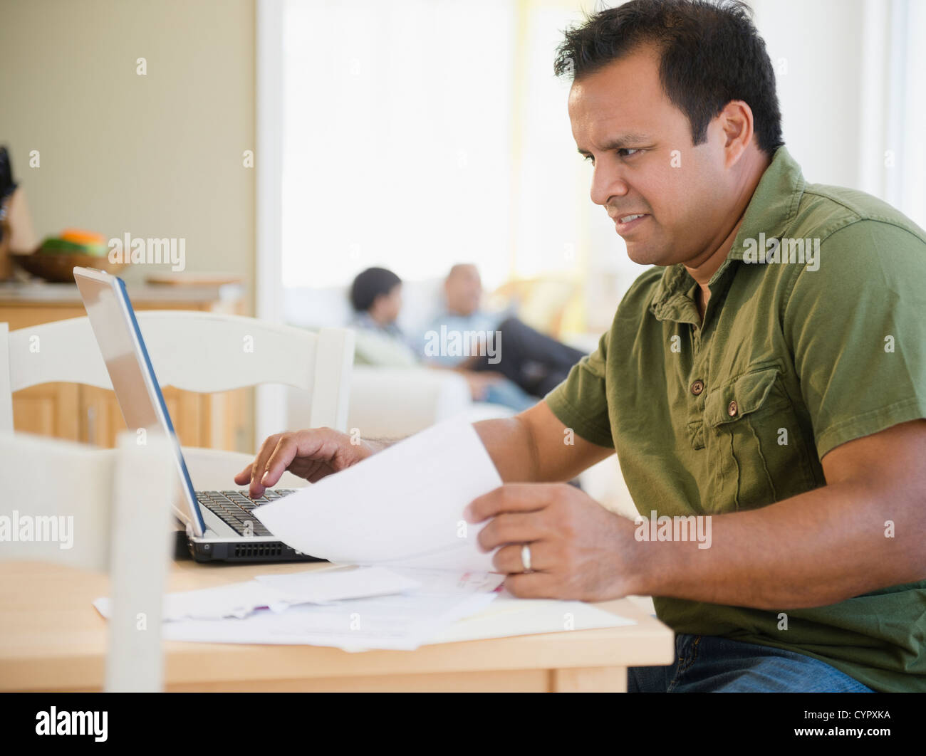 Hispanic man using laptop Stock Photo - Alamy