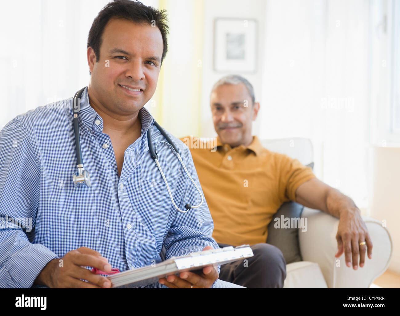 Hispanic doctor examining patient Stock Photo - Alamy