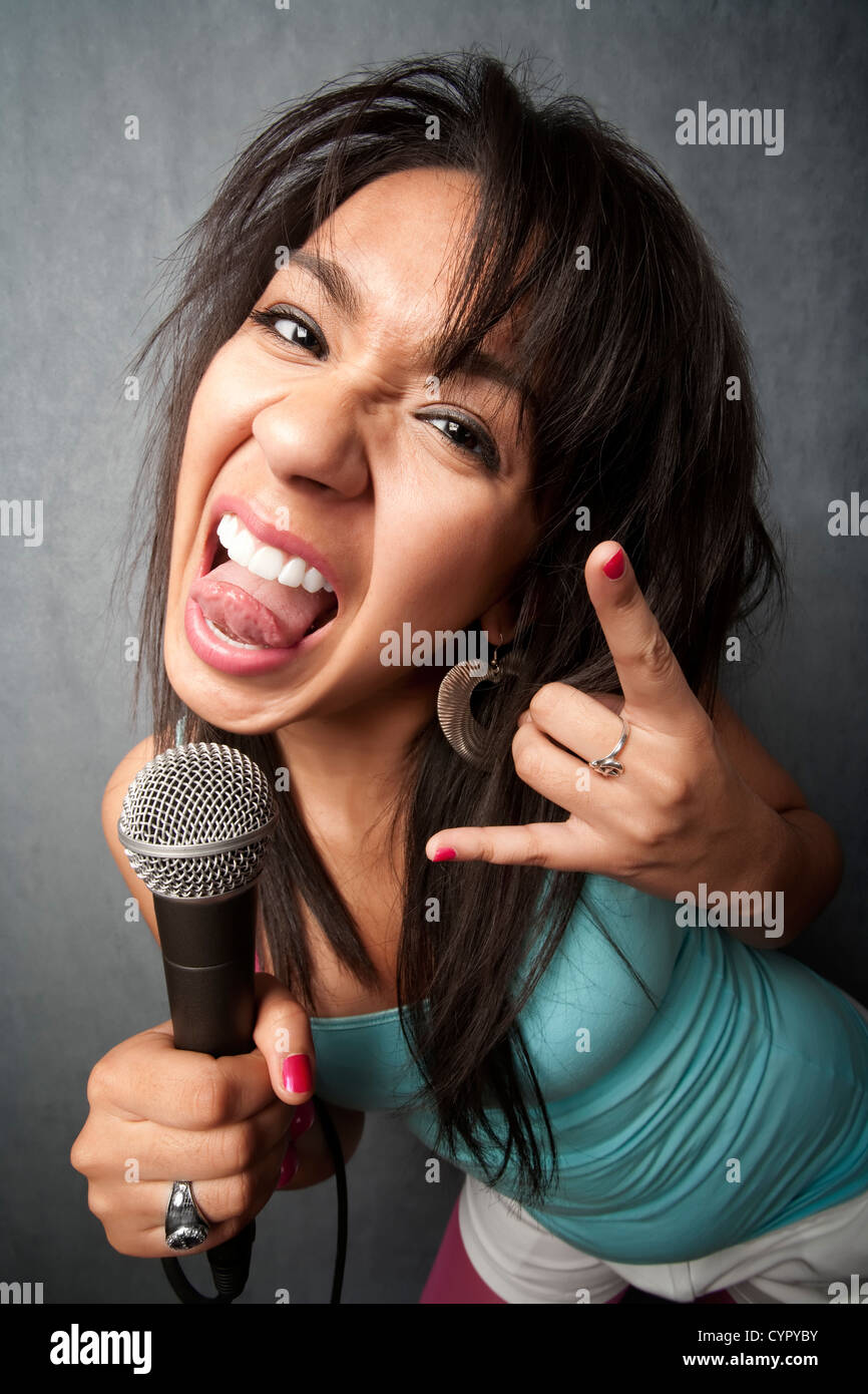 Pretty young singer with a large microphone Stock Photo - Alamy