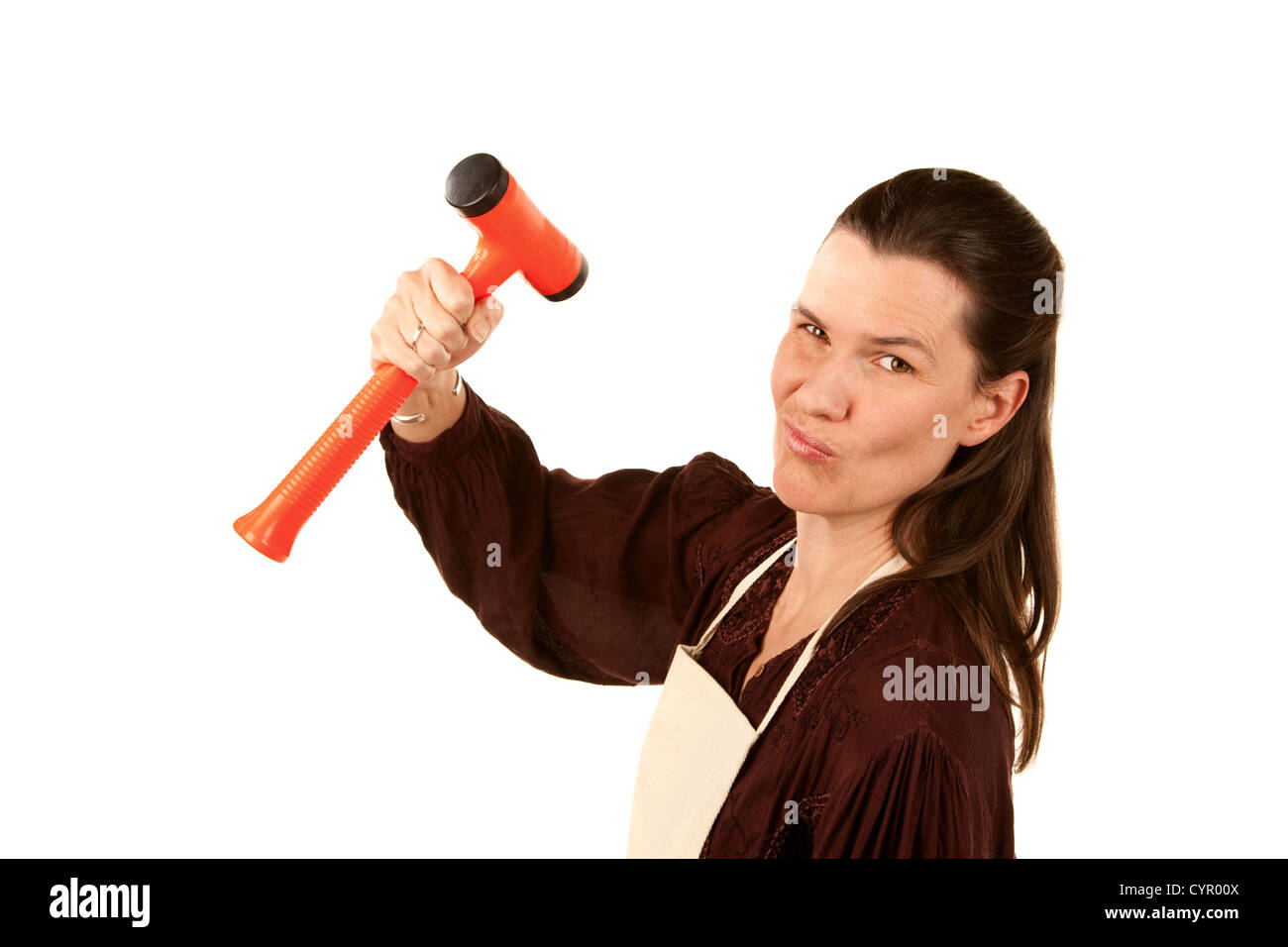 Pretty adult woman holding a hammer aloft Stock Photo - Alamy