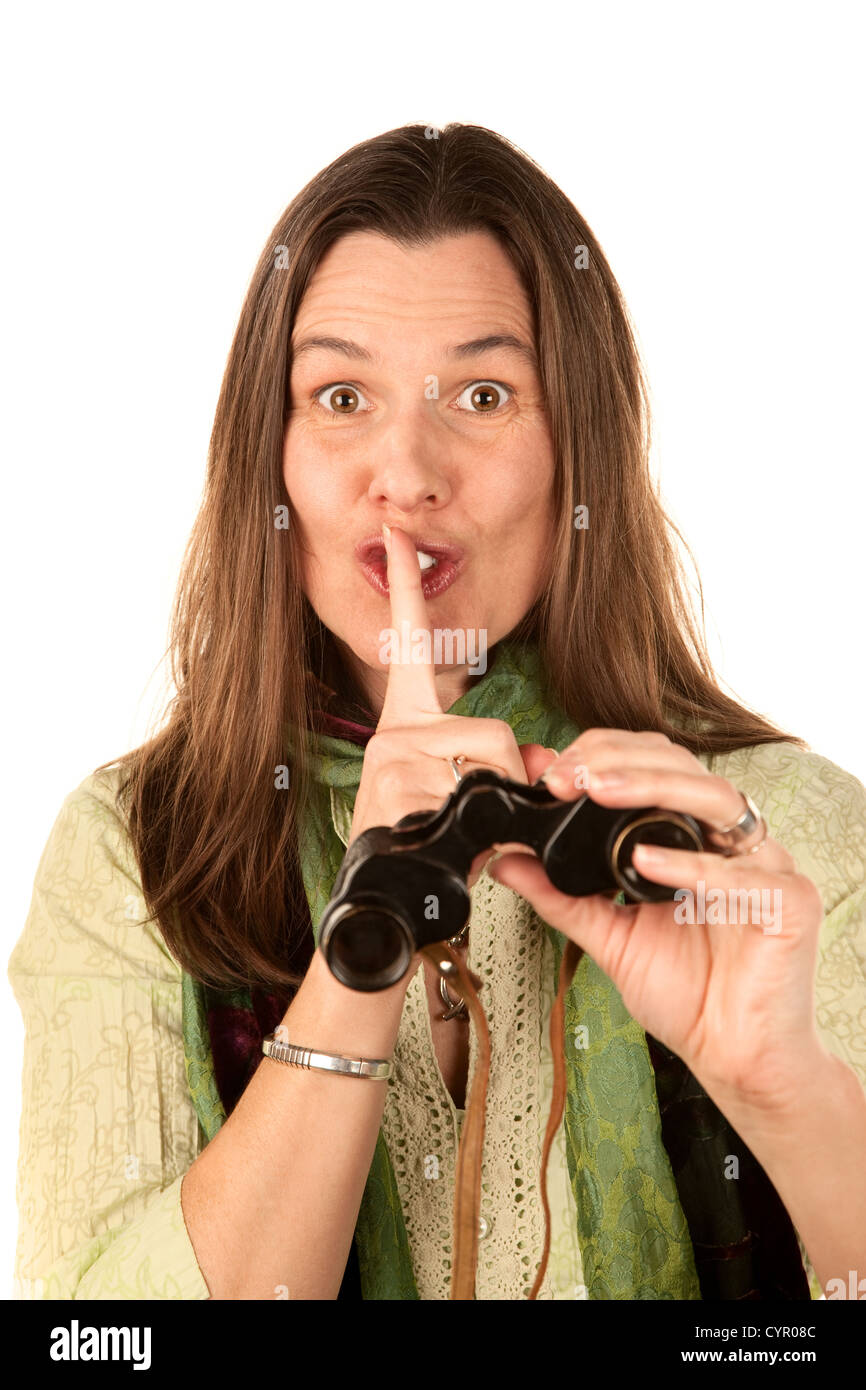 Pretty adult woman putting finger to lips and using binoculars Stock ...