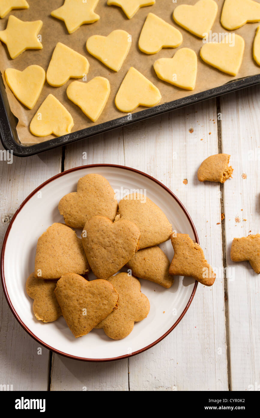 Homemade Christmas cookies before and after baking Stock Photo - Alamy