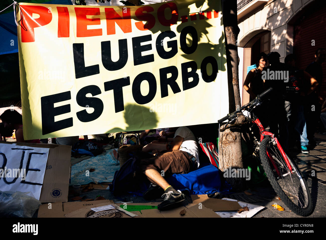 A placard reading "Pienso... luego estorbo", meaning " I think ...