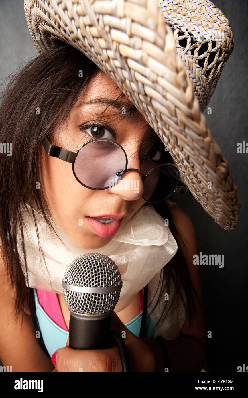 Pretty young singer with a large microphone Stock Photo - Alamy