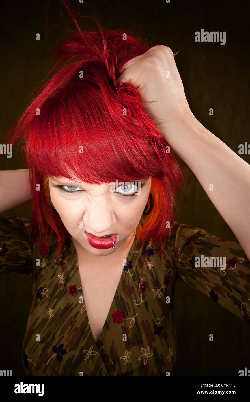 Pretty punky girl with brightly dyed red hair Stock Photo - Alamy