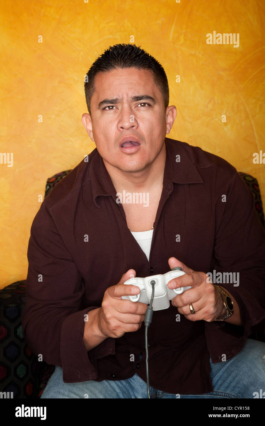Handsome Hispanic man playing Video game Stock Photo - Alamy