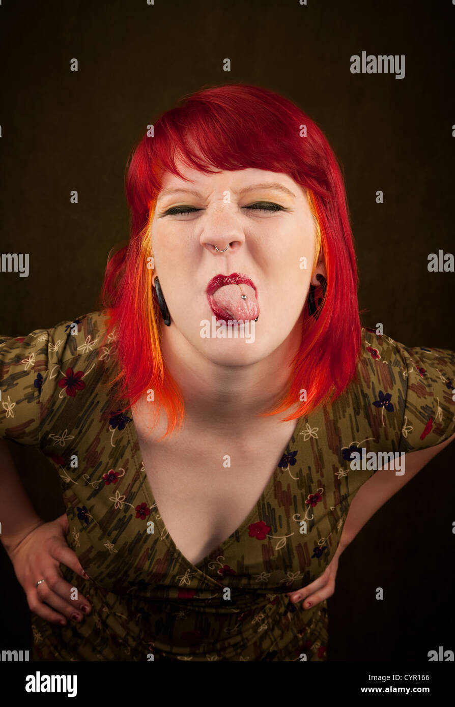 Pretty punky girl with brightly dyed red hair Stock Photo - Alamy
