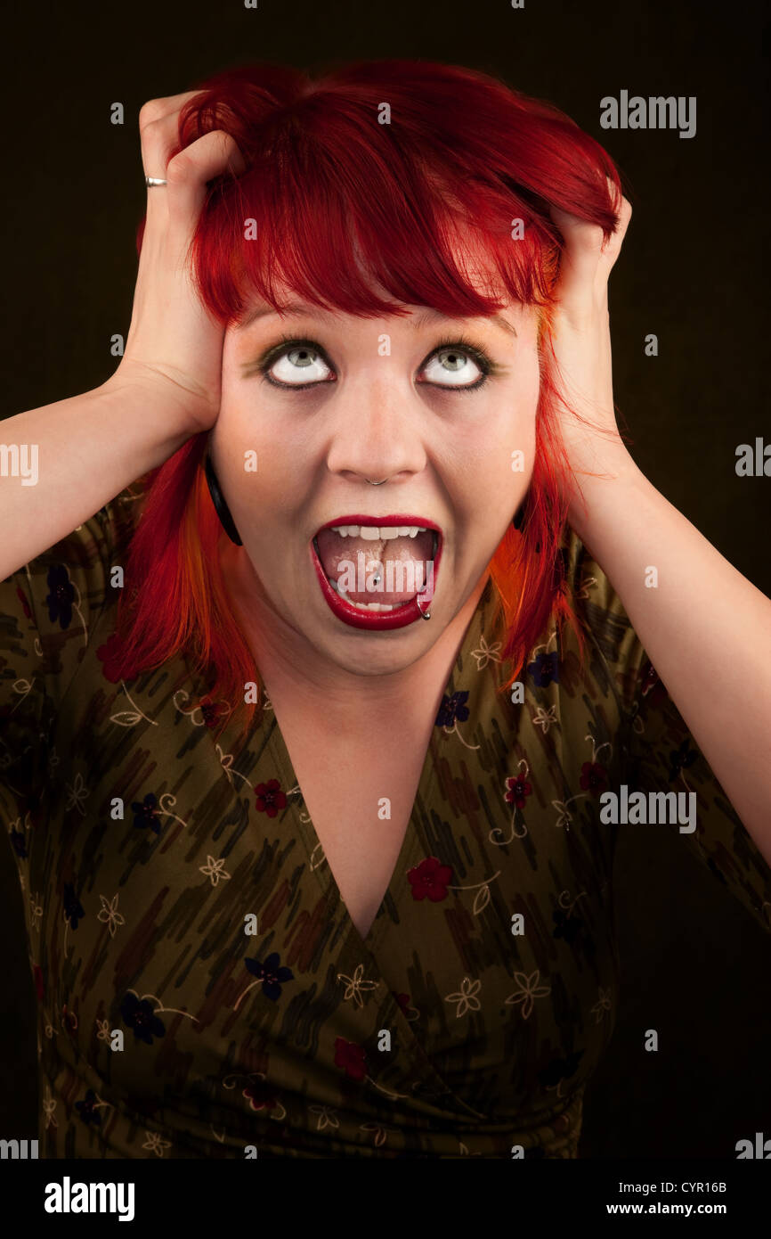 Pretty punky girl with brightly dyed red hair Stock Photo - Alamy