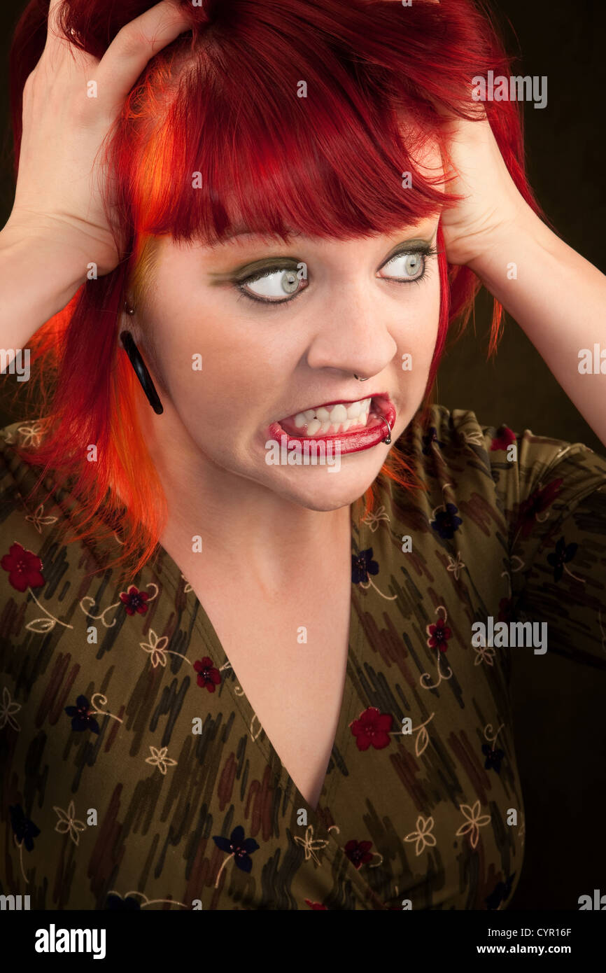 Pretty punky girl with brightly dyed red hair Stock Photo - Alamy