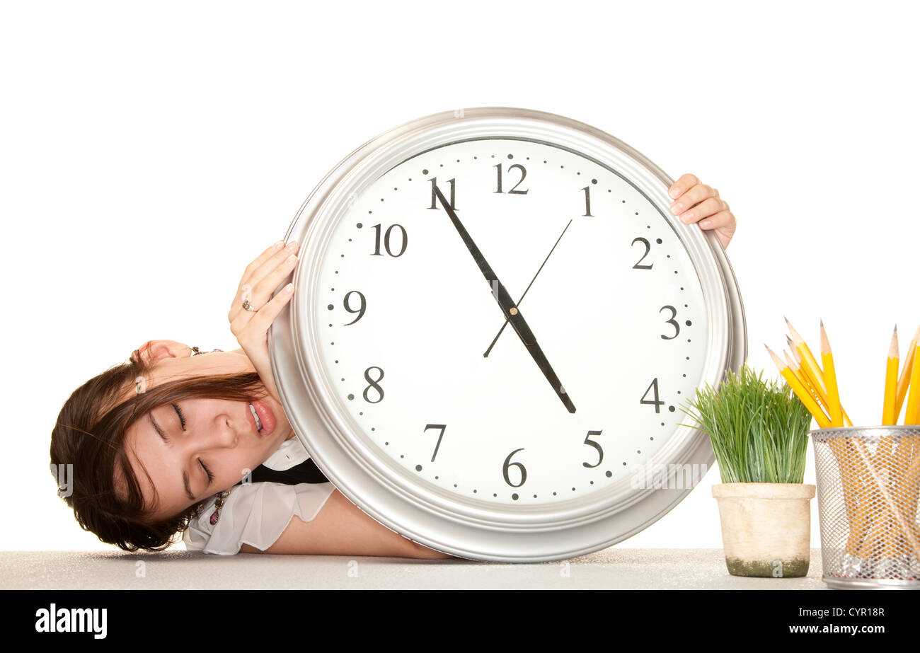 Woman at work holding up large office clock Stock Photo - Alamy