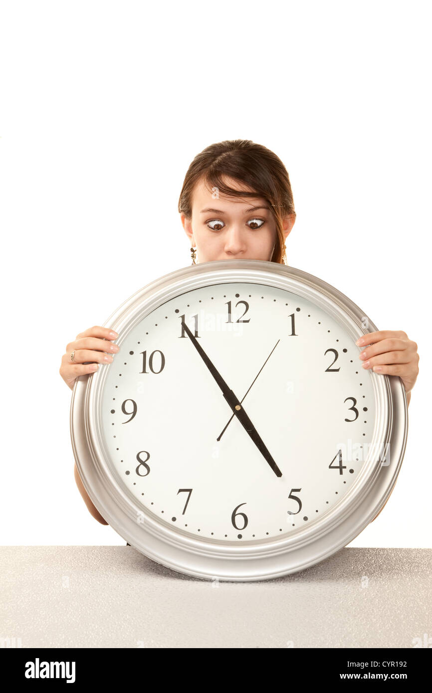 Woman at work holding up large office clock Stock Photo - Alamy