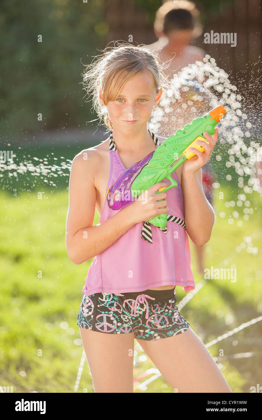Caucasian girl holding a water gun Stock Photo - Alamy