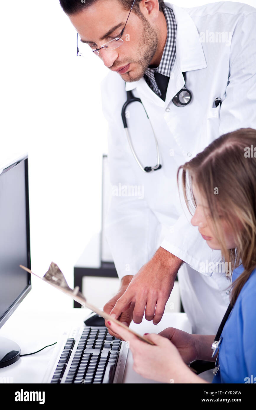 Two busy doctors discussing with the medical reports in their hospital ...