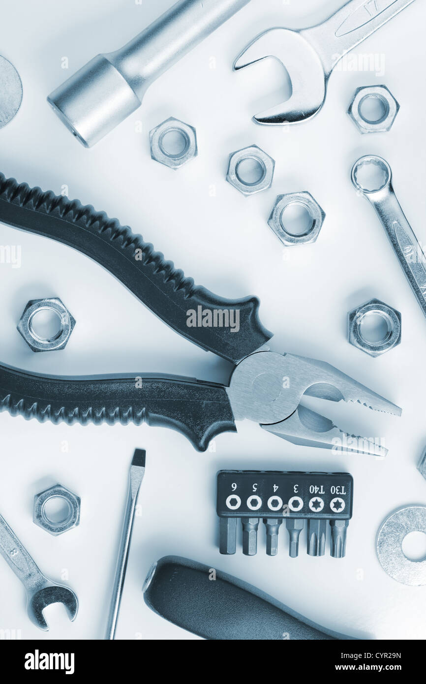 Tools and nuts. Above view. Blue toned Stock Photo - Alamy