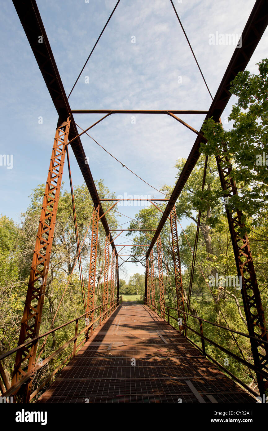 An abandoned one-lane county road and steel truss bridge over the San ...