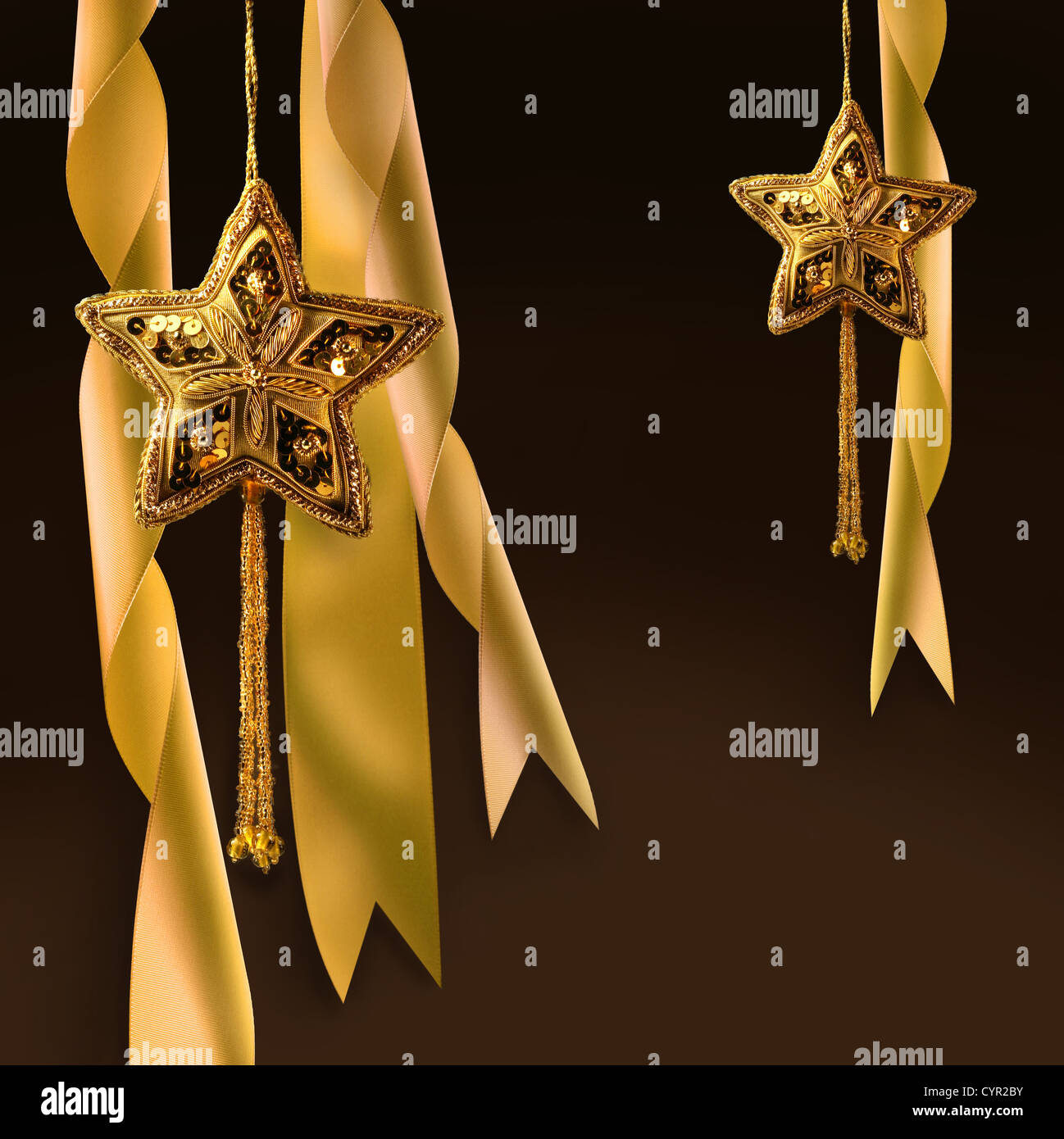 Gold christmas star with ribbons against dark background Stock Photo ...