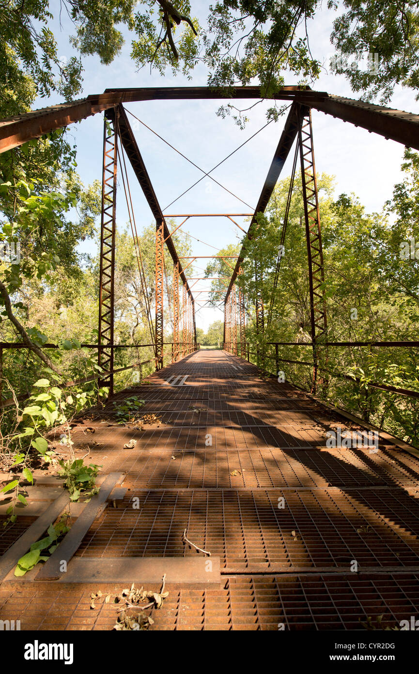 An abandoned one-lane county road and steel truss bridge over the San ...