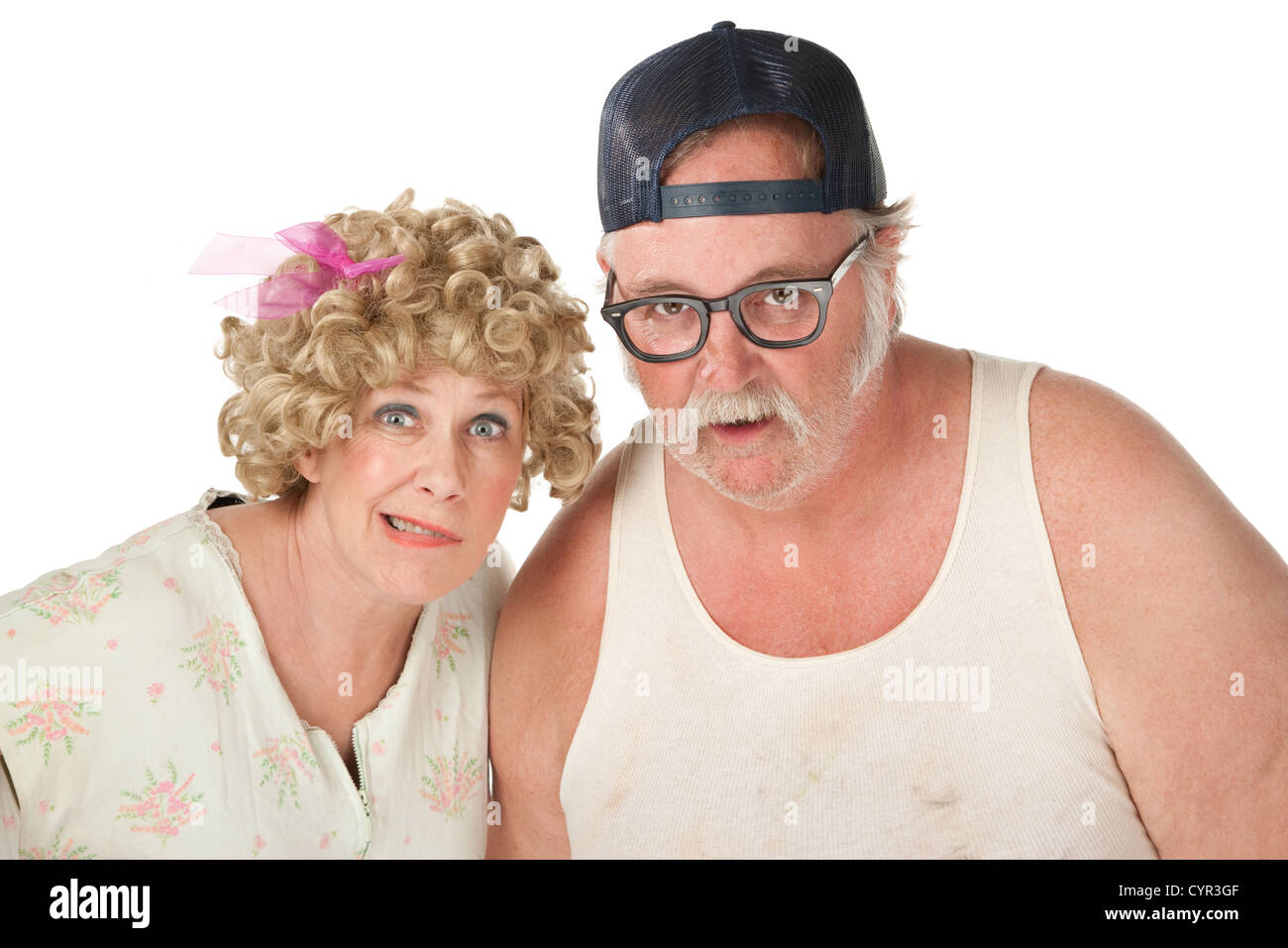Unsure homely couple looking out on white background Stock Photo - Alamy