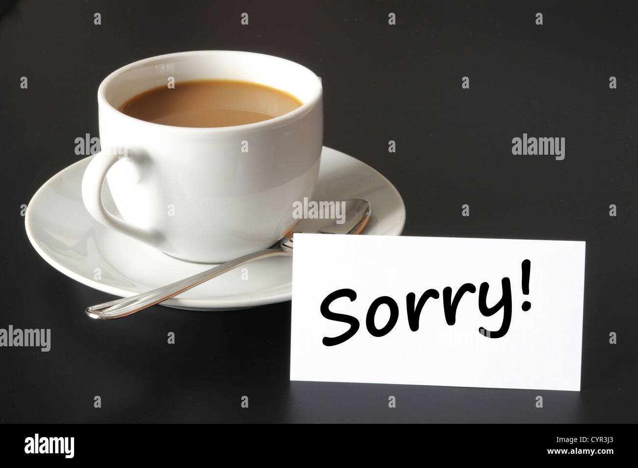 sorry message on paper and cup of coffe on black Stock Photo - Alamy