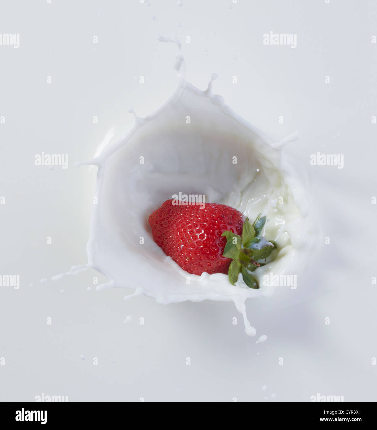 Strawberry dropping into milk Stock Photo - Alamy
