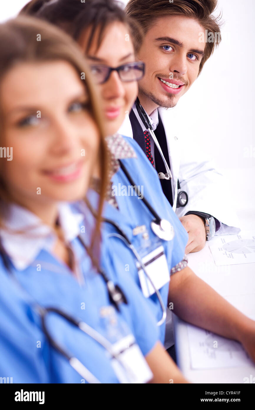 Hospital staff sitting in a row over white background Stock Photo - Alamy