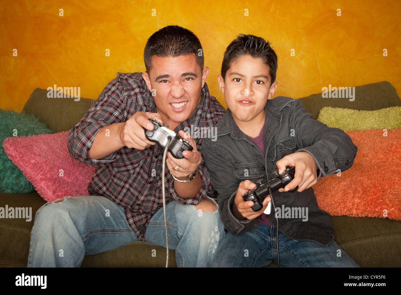 Attractive Hispanic Man and Boy Playing a Video Game with Handheld ...