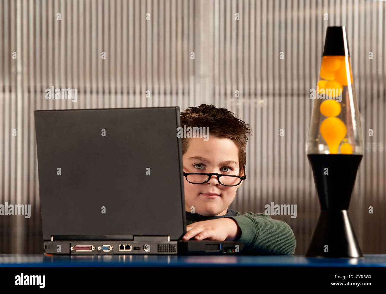 Cute young boy dressed as an adult working on a laptop computer Stock ...
