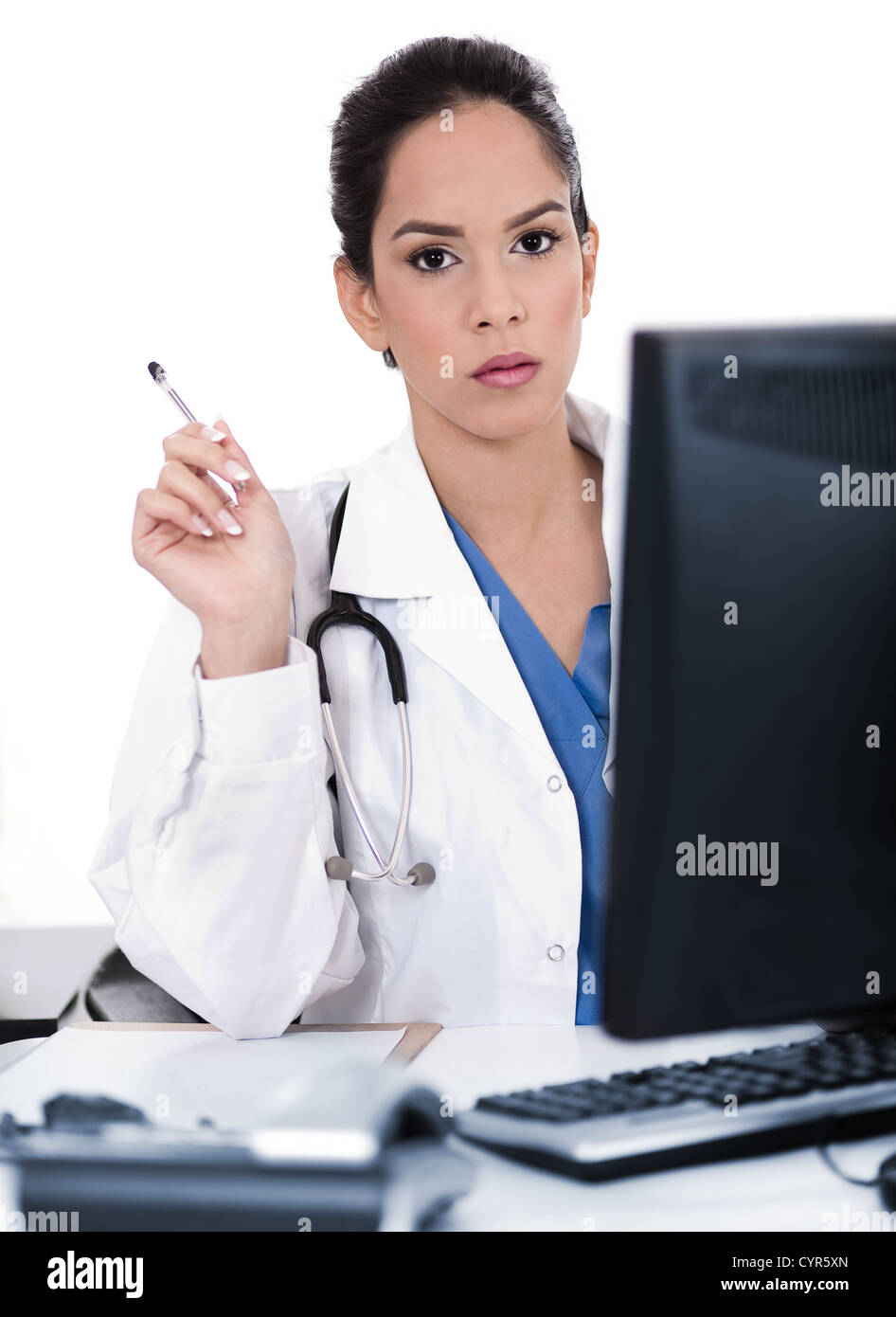 Serious young doctor looking strangely at us over white background ...